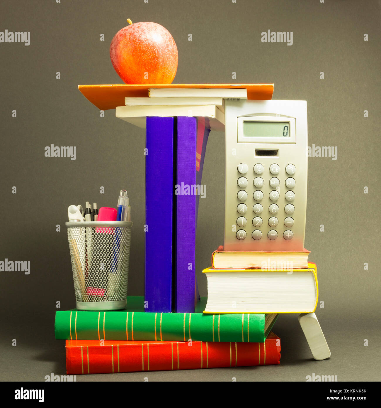 Concept of education. Stack of school books with calculator, marker and ...