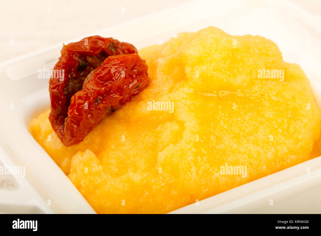 Polenta with dry tomato Stock Photo - Alamy