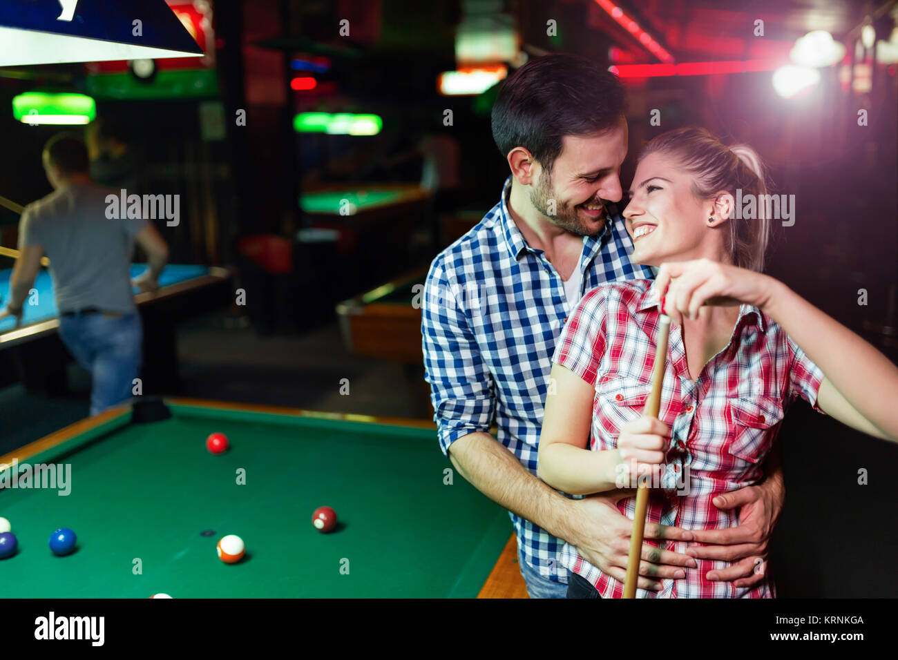 Young couple playing together pool in bar Stock Photo - Alamy
