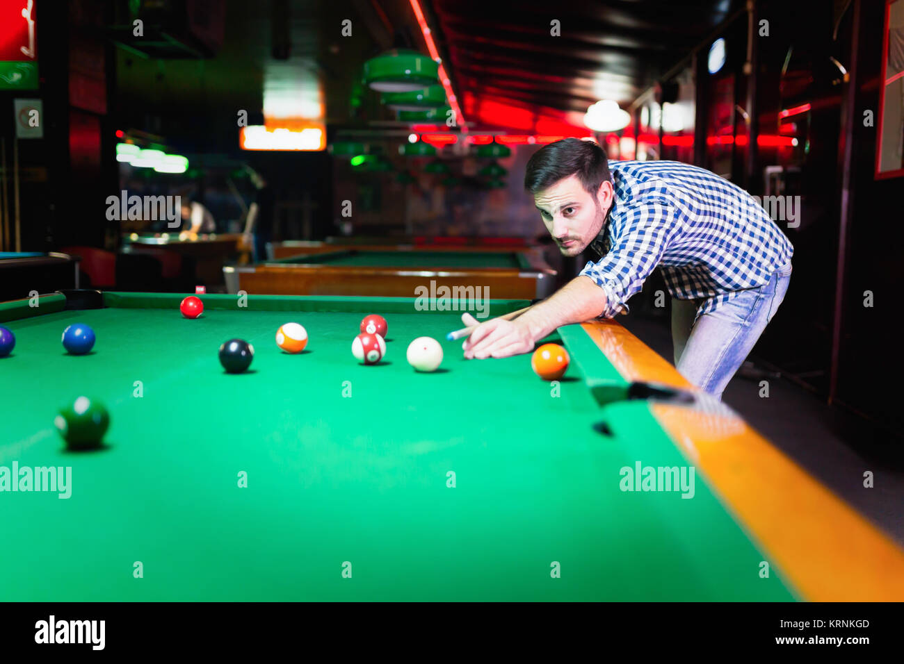 Hansome man playing pool in bar alone Stock Photo - Alamy