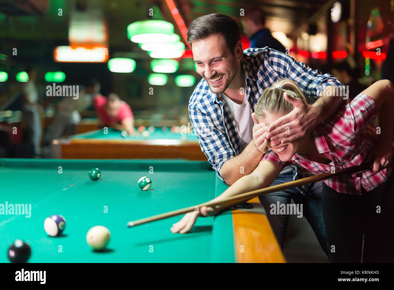 Young couple playing together pool in bar Stock Photo - Alamy