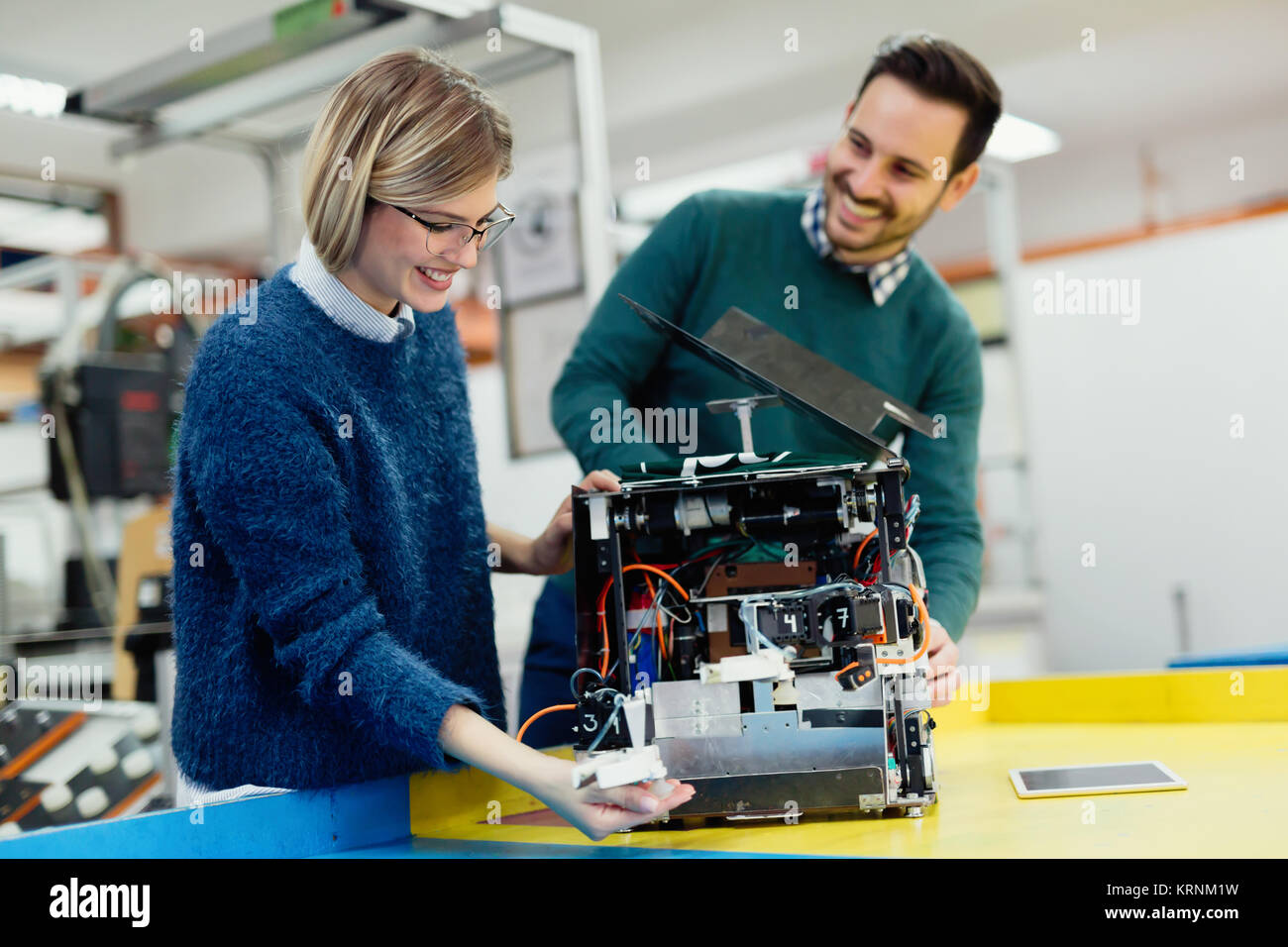 Young students of robotics preparing robot for testing Stock Photo - Alamy