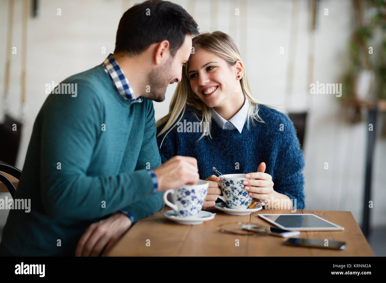 Young beautiful couple having date in coffee shop Stock Photo - Alamy