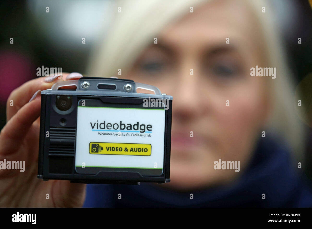 A member of ScotRail staff holds a new body-worn CCTV camera at ...