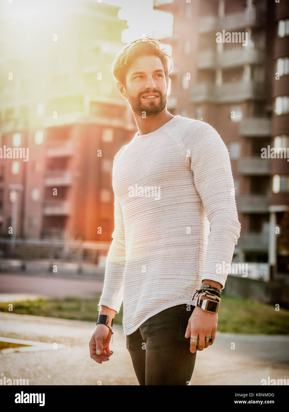 One handsome young man in urban setting in European city, standing ...