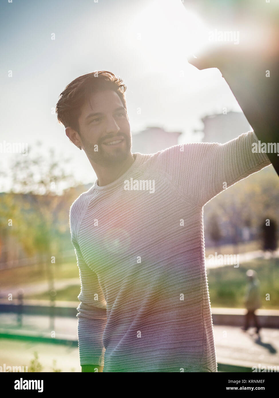 One handsome young man in urban setting in European city, standing ...