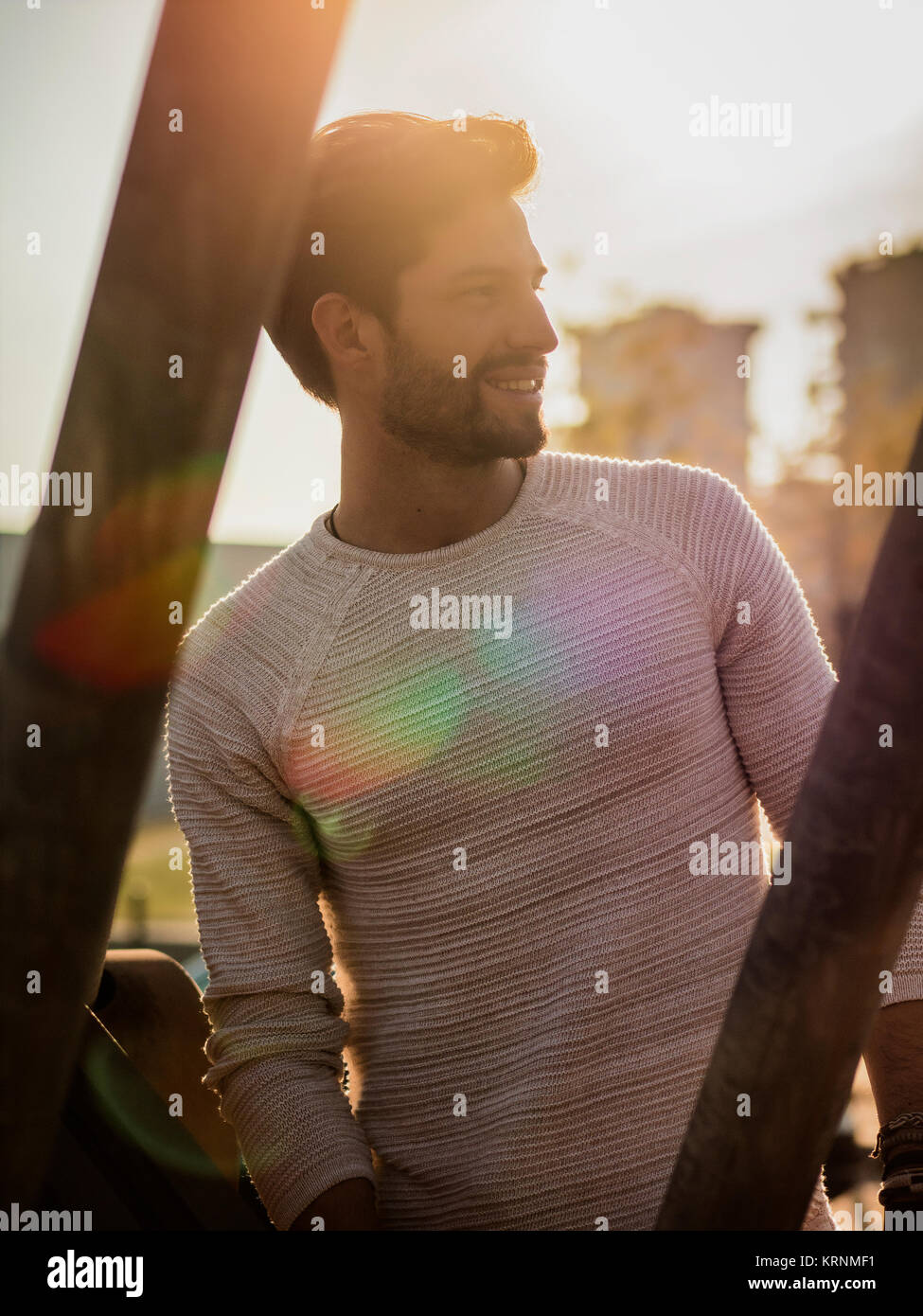 One handsome young man in urban setting in European city, standing ...