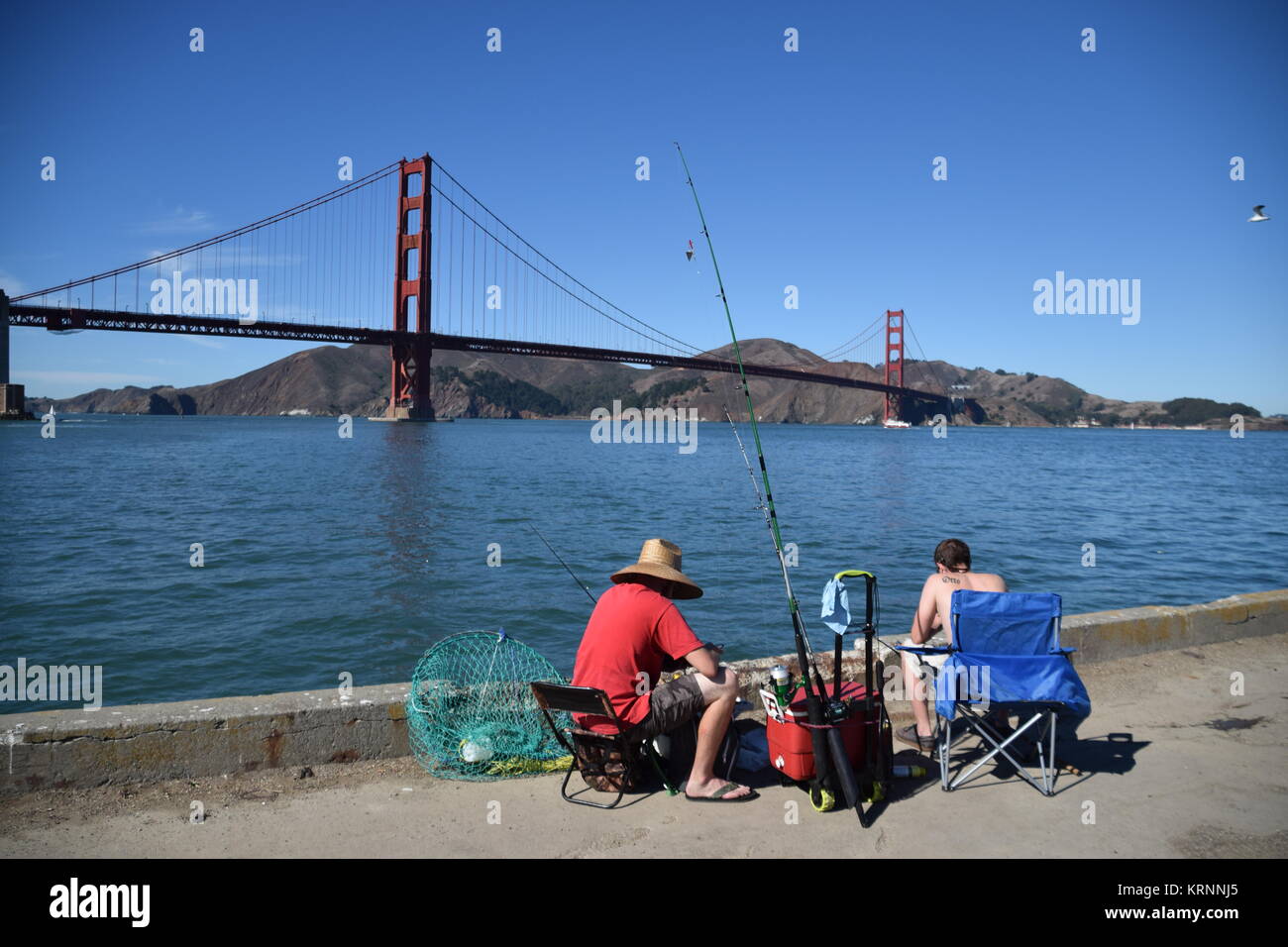 Fishermen on Torpedo Wharf with view of Golden Gate Bridge Stock Photo ...