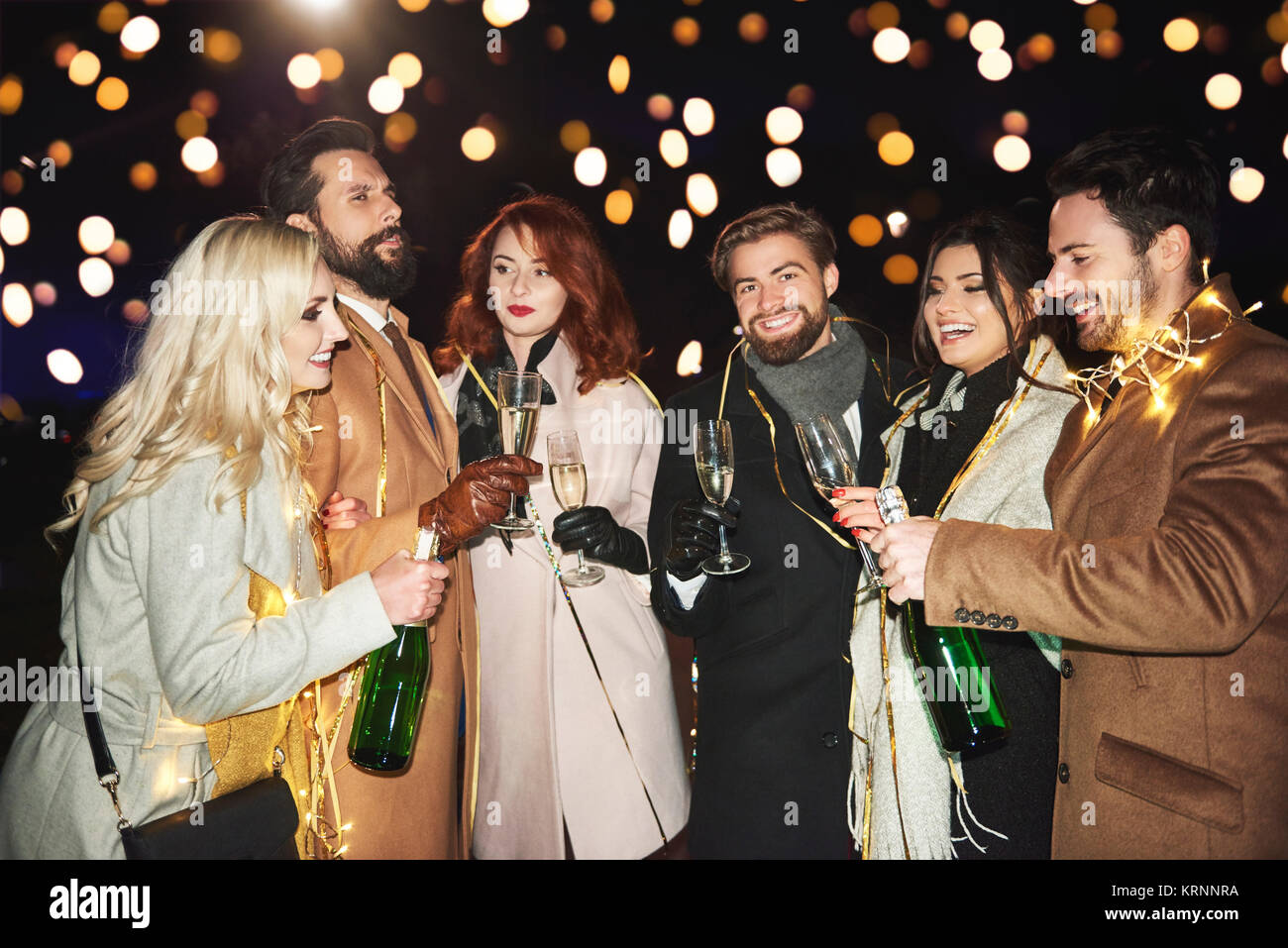 Group of friends celebrating new year together Stock Photo - Alamy