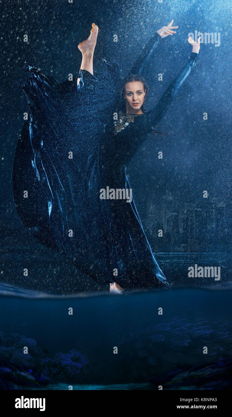 The young beautiful modern dancer dancing under water drops Stock Photo ...