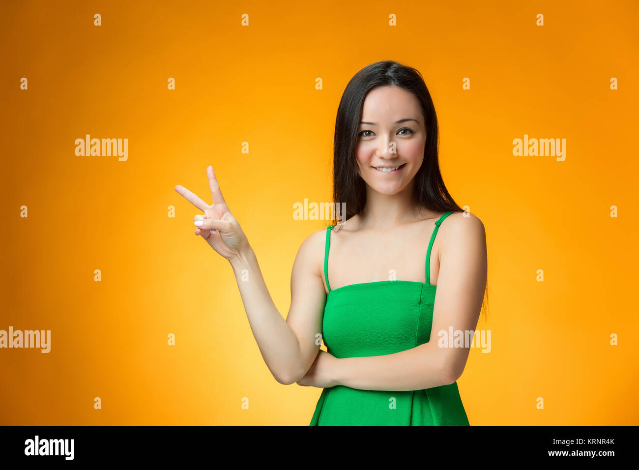 The happy Chinese girl on yellow background Stock Photo - Alamy