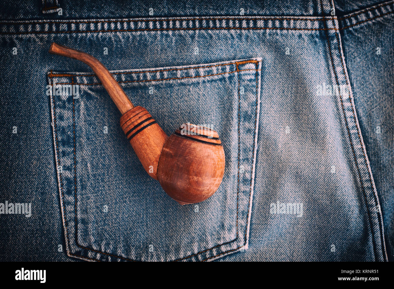 Wooden pipe for tobacco is in the back pocket of old blue jeans Stock ...