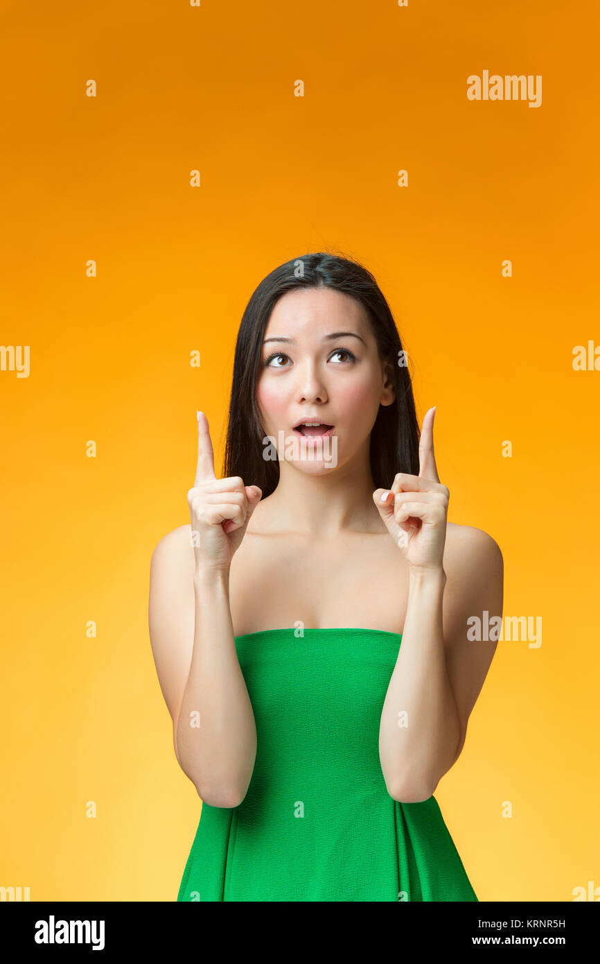 The happy Chinese girl on yellow background Stock Photo - Alamy