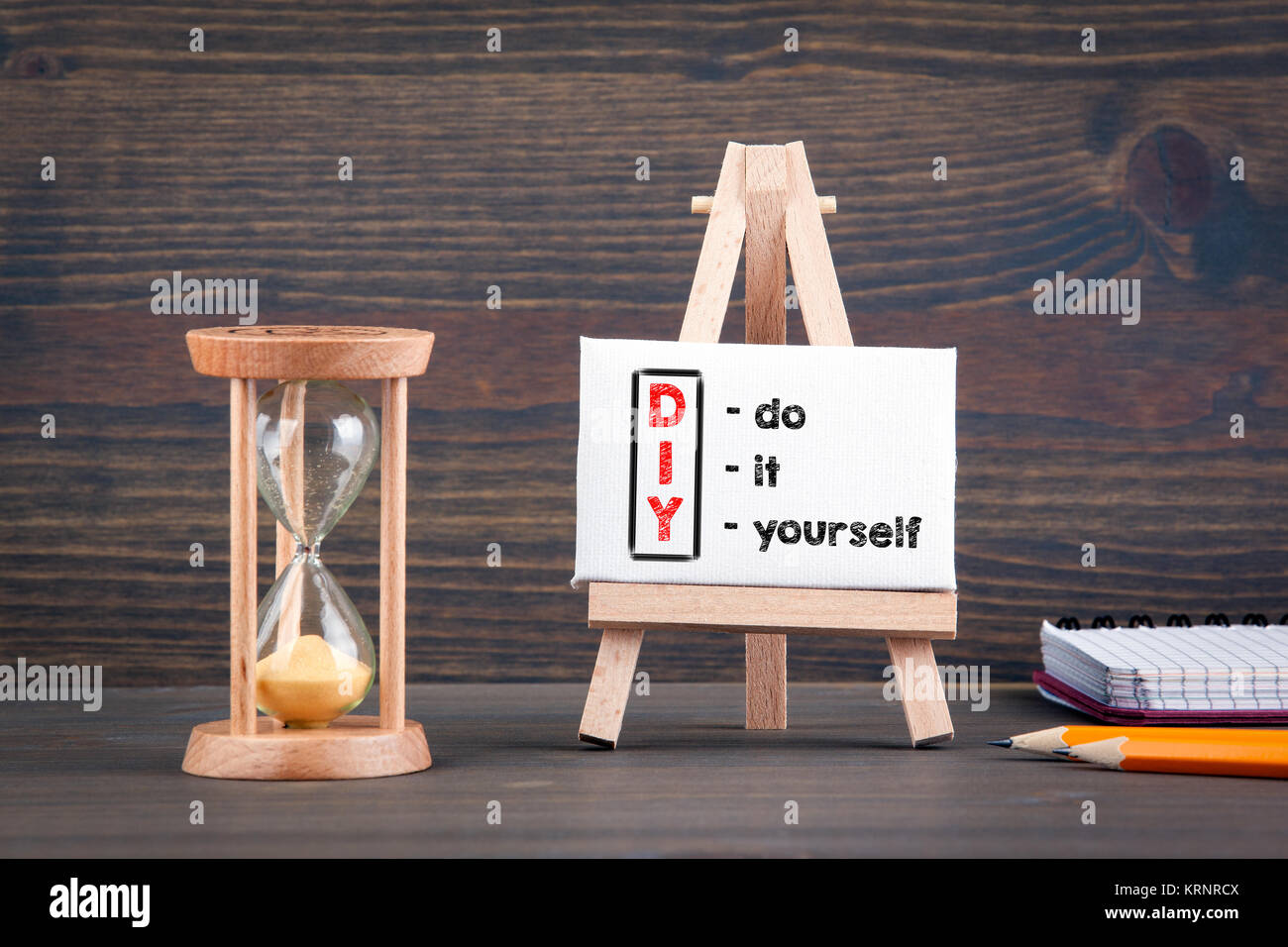 DIY do it yourself. Sandglass, hourglass or egg timer on wooden table ...