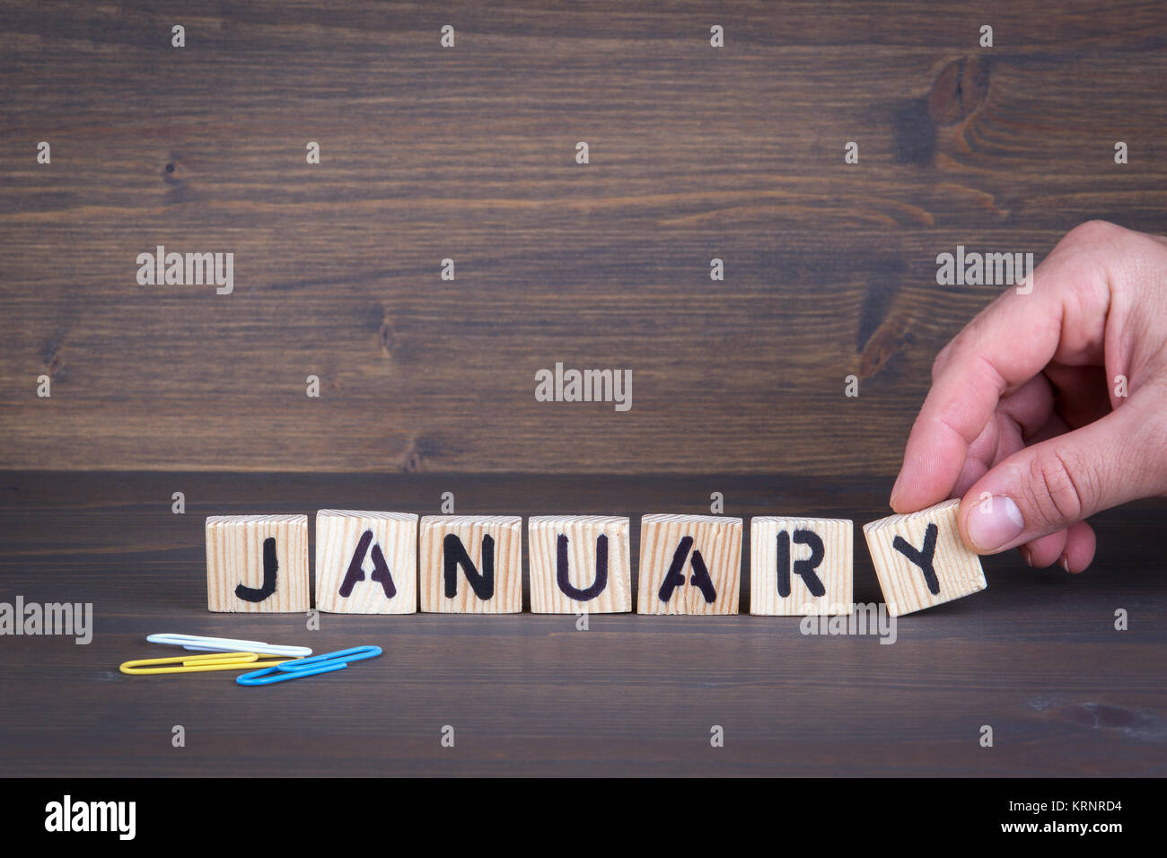 january. Wooden letters on the office desk, informative and ...