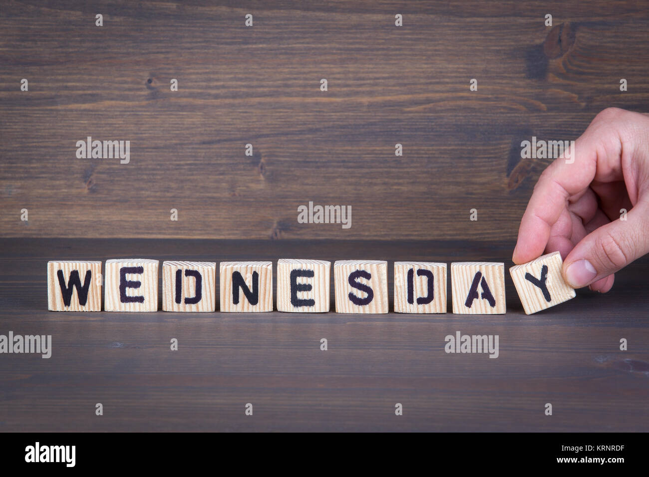wednesday. Wooden letters on the office desk, informative and ...