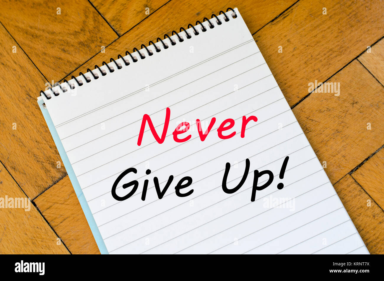 Never give up text concept on notebook Stock Photo - Alamy