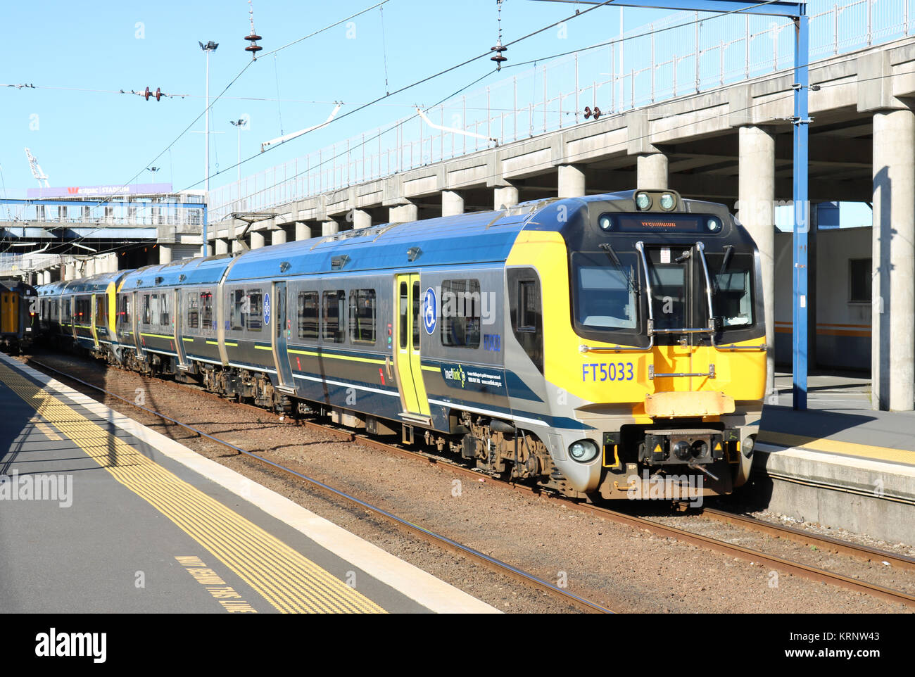 Metlink liveried 2-car Matangi electric multiple unit train arriving at a platform Wellington ...