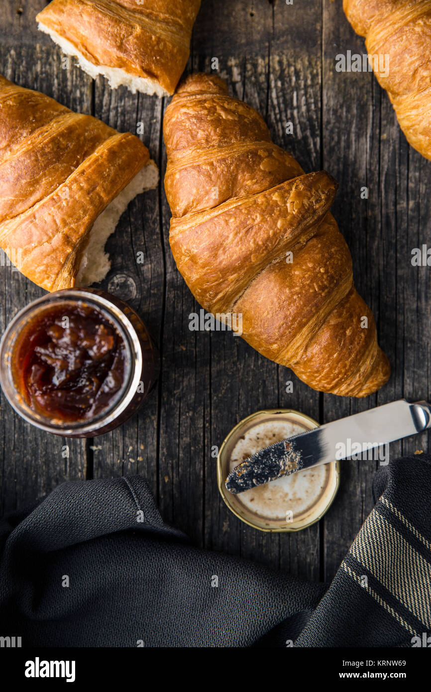 Tasty buttery croissant and jam in jar Stock Photo - Alamy