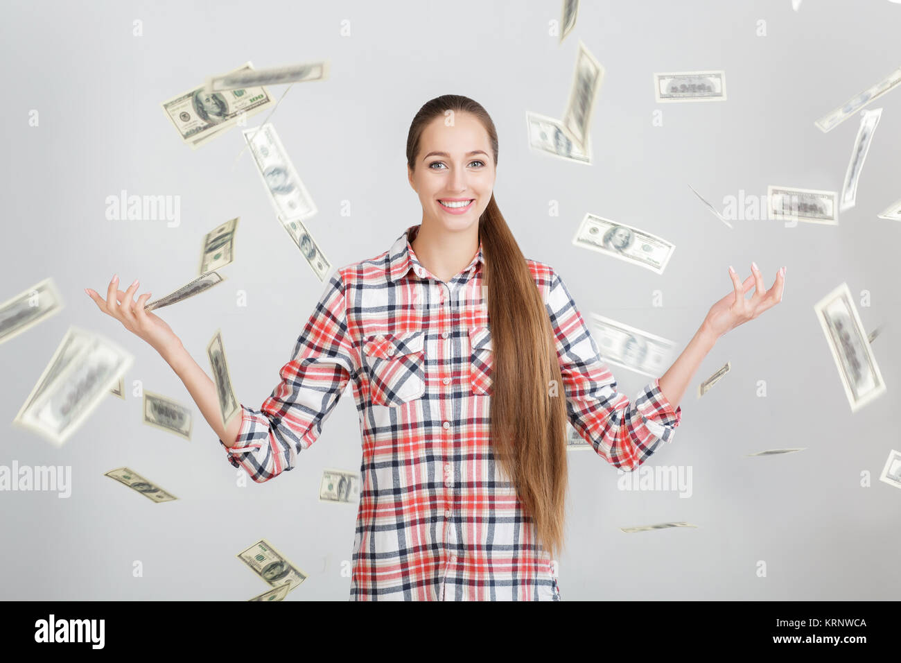 happy woman standing under money rain Stock Photo - Alamy