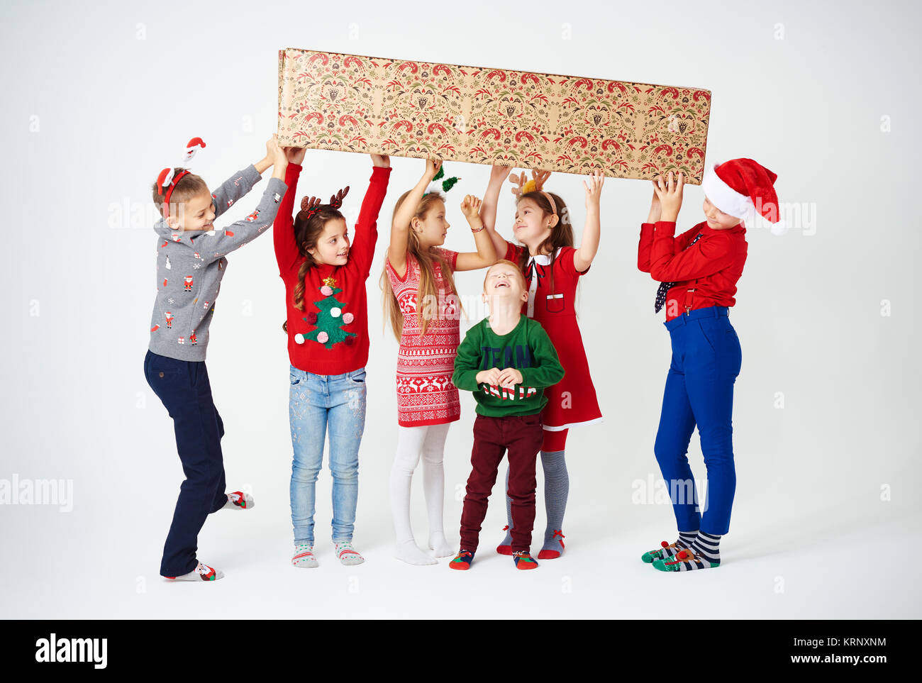 Playful children having a fun at christmas Stock Photo - Alamy