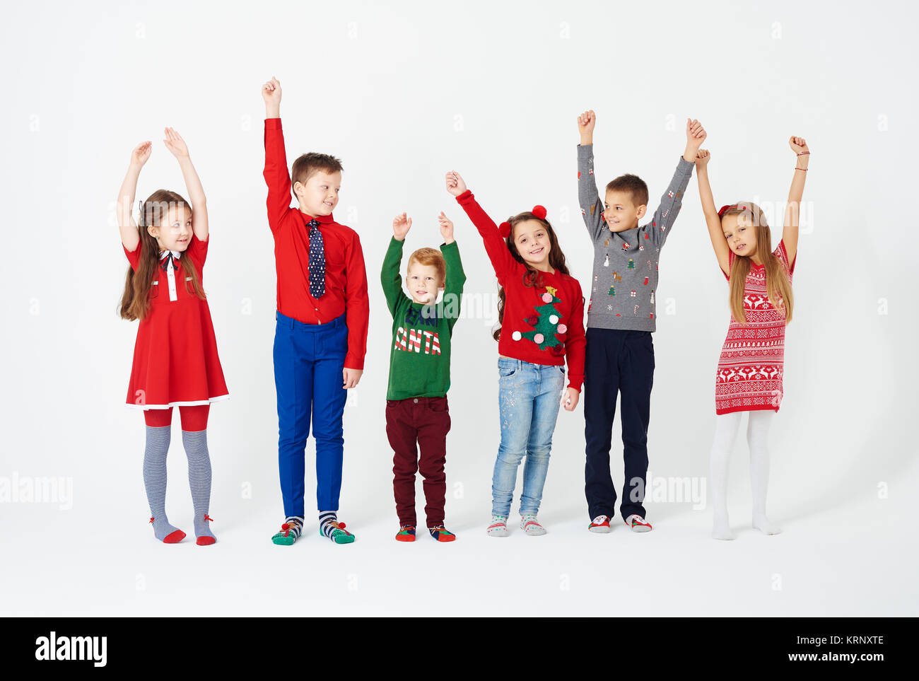 Front view of children hands up standing in a row Stock Photo - Alamy