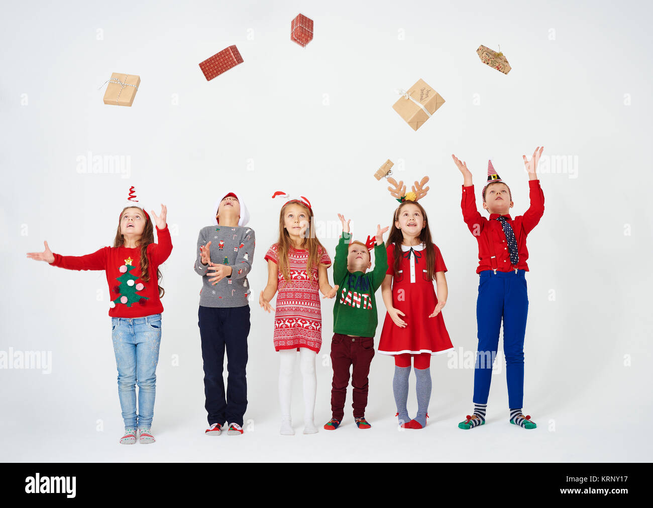Cheerful children throwing their gift Stock Photo - Alamy