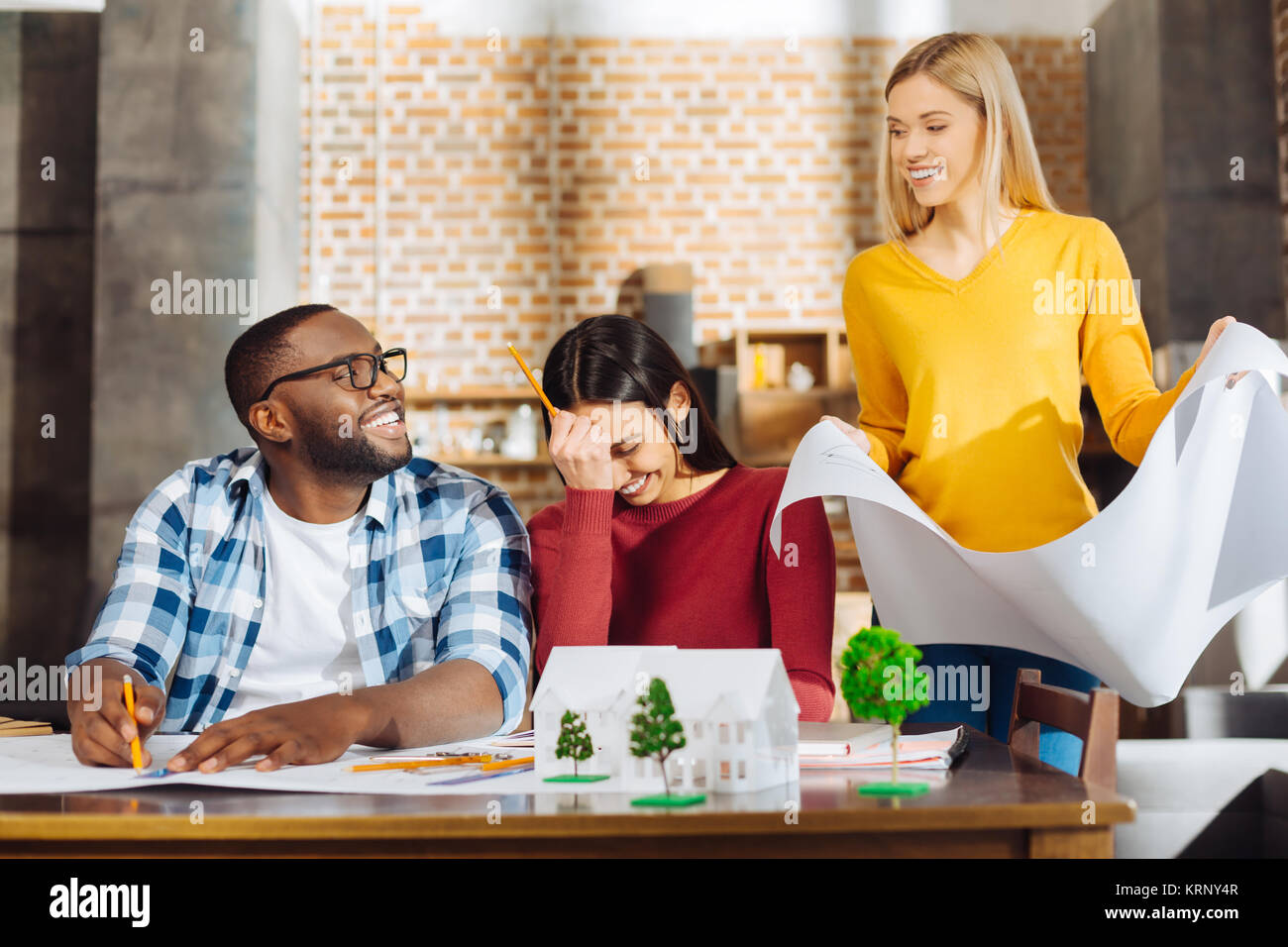 Three awesome optimistic colleagues working on project Stock Photo - Alamy