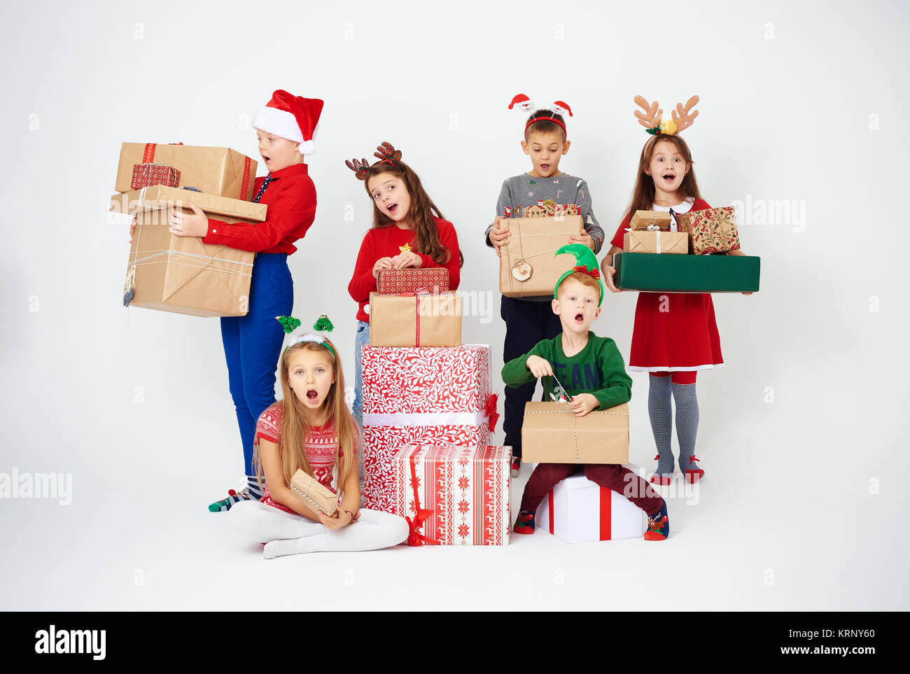 Surprised children with gifts at studio shot Stock Photo - Alamy