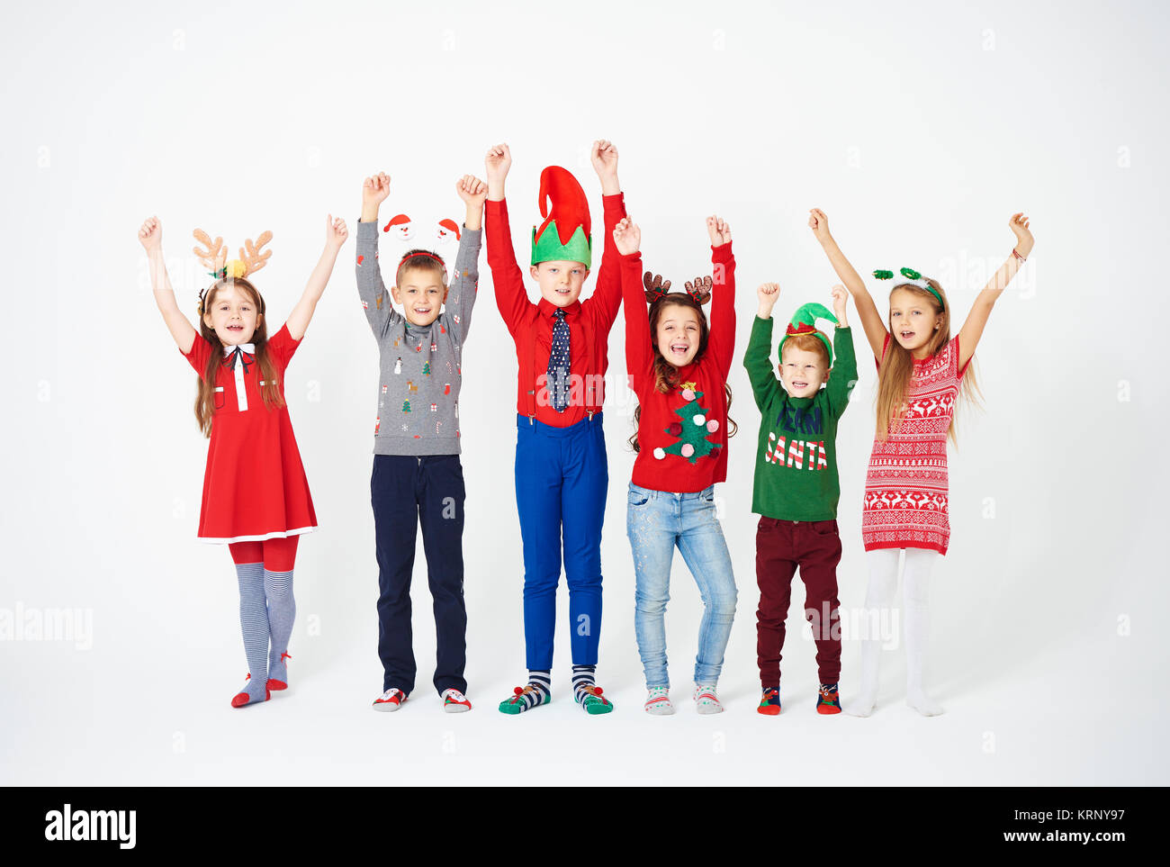 Full length portrait of children with hands up Stock Photo - Alamy