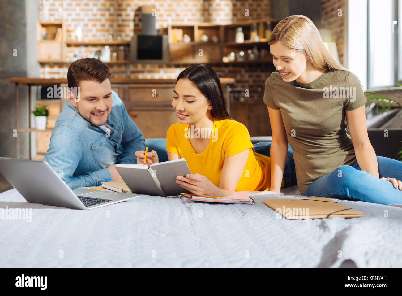 Three pensive nice friends doing homework Stock Photo - Alamy