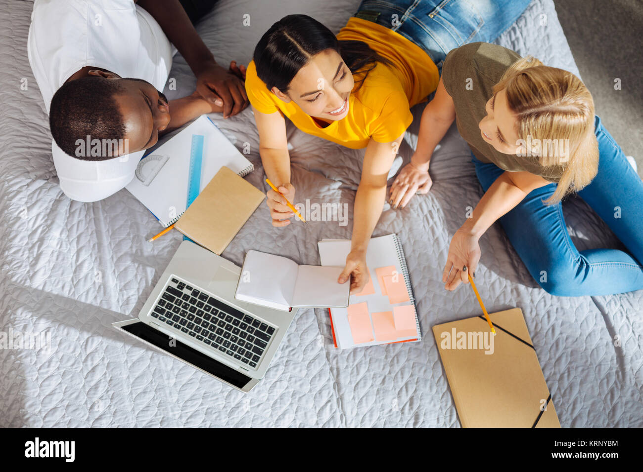 Three happy positive students coming up with ideas Stock Photo - Alamy