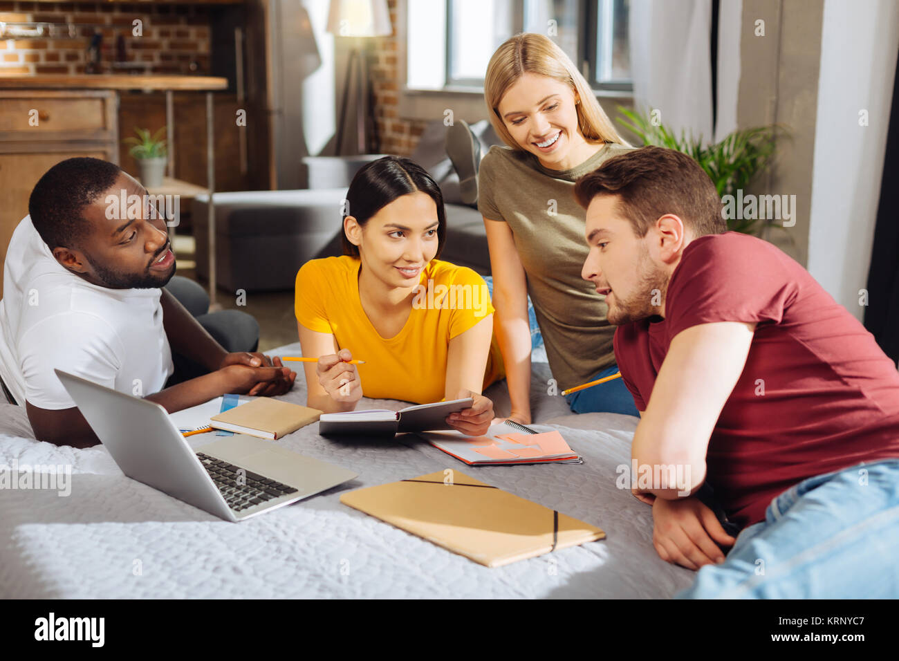 Four pensive energetic students preparing for class Stock Photo - Alamy