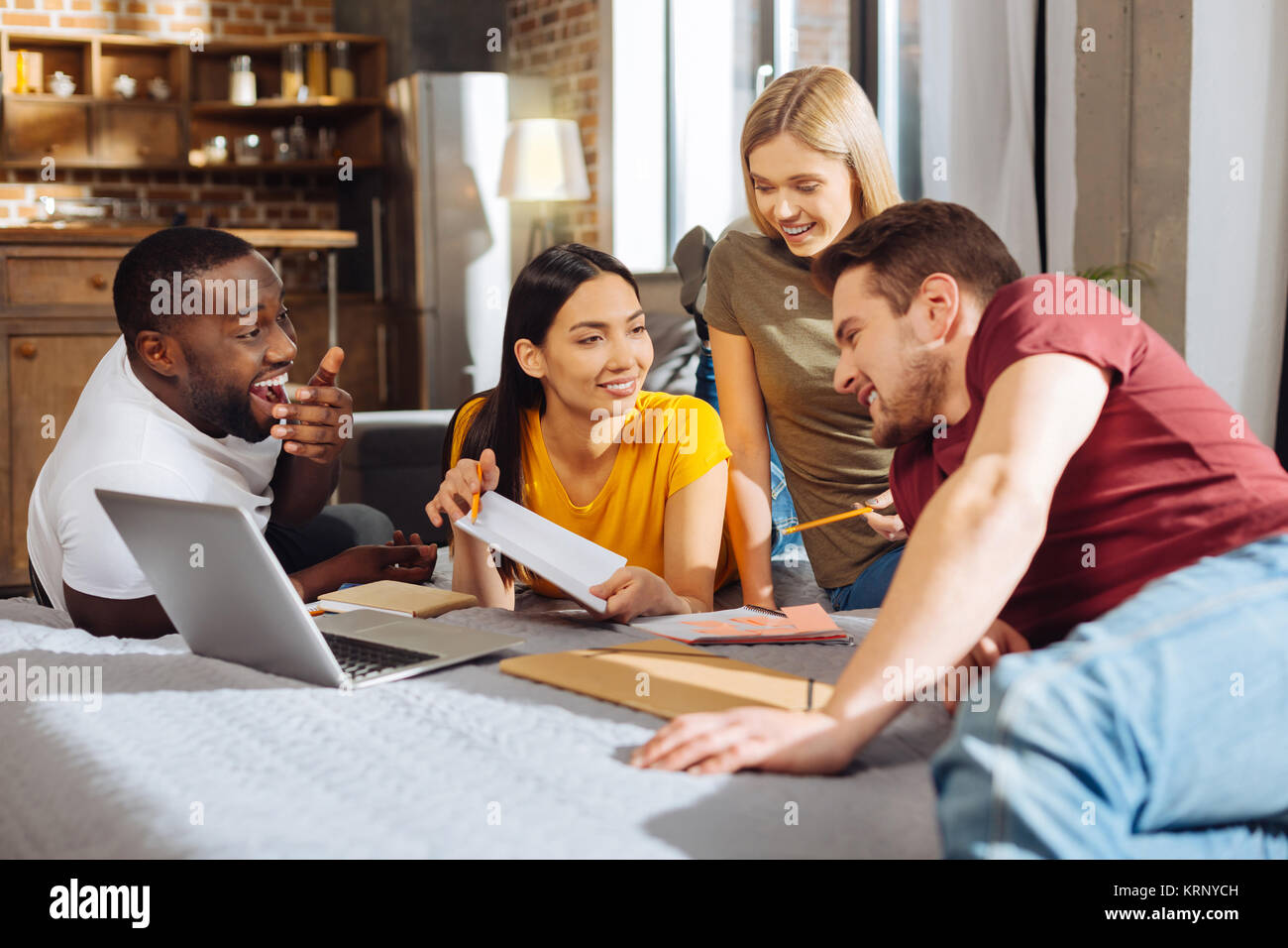 Four funny happy students preparing for test Stock Photo - Alamy