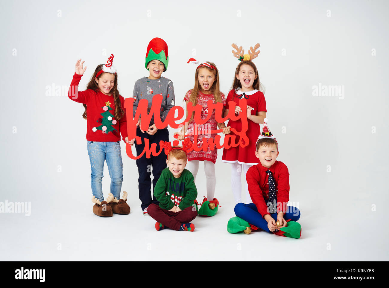 Group of children celebrating christmas together Stock Photo - Alamy