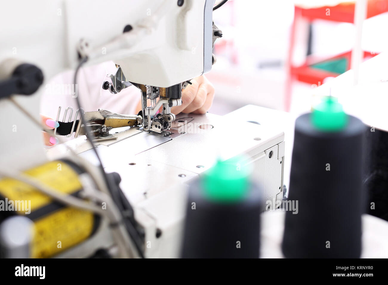 sewing. seamstress at the machine. clothing production,sewing on a ...