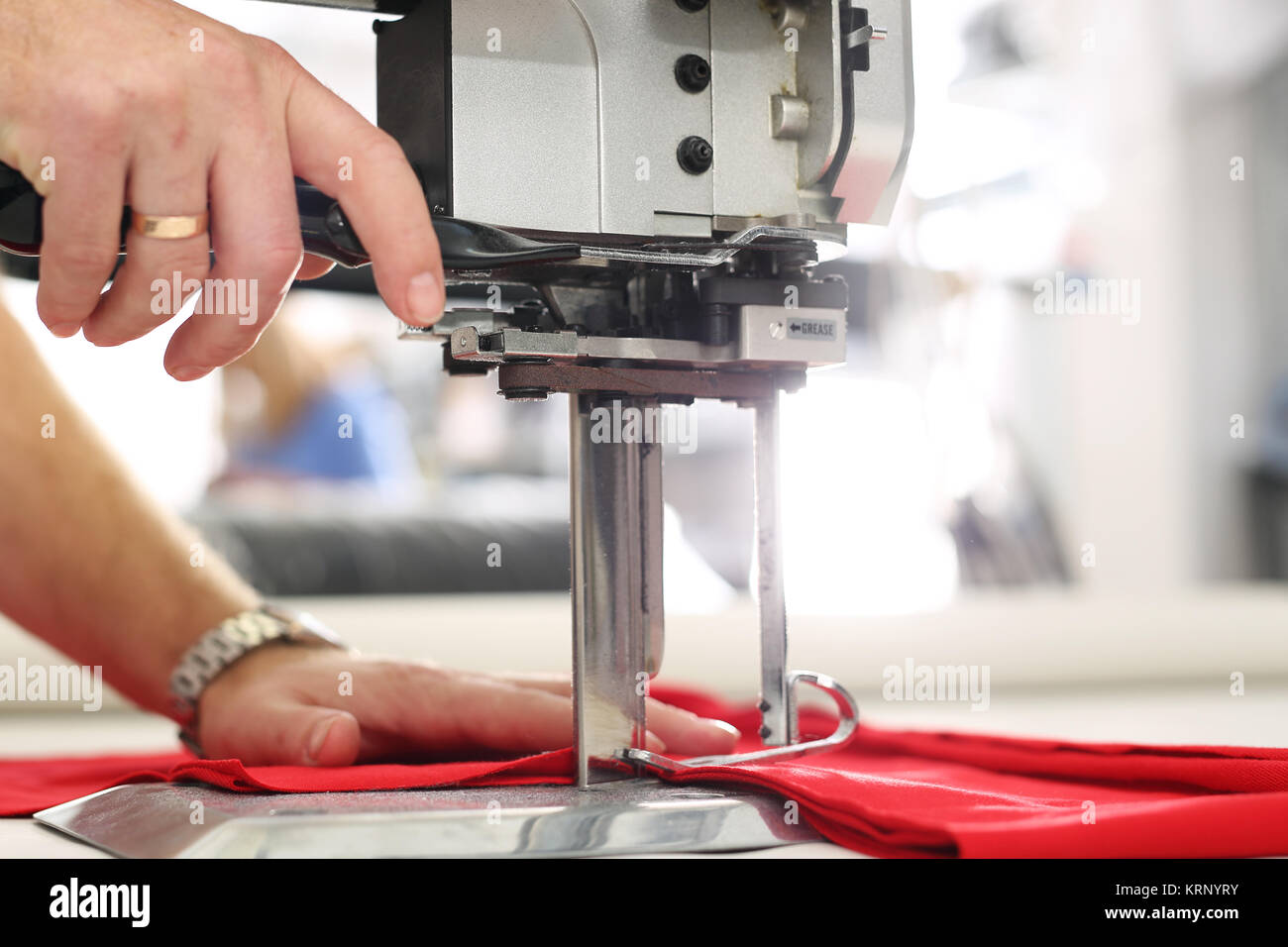 cutting fabric,work in a sewing room Stock Photo - Alamy