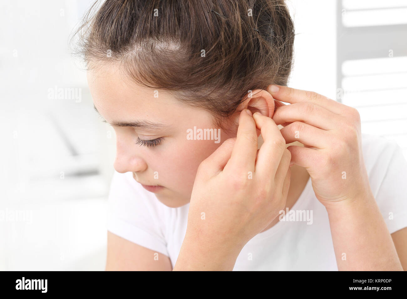 the girl assumes hearing aid Stock Photo - Alamy