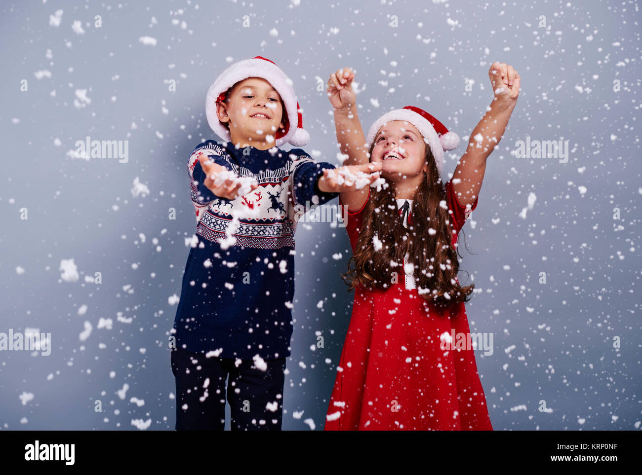 Happy children catching snowflake Stock Photo - Alamy