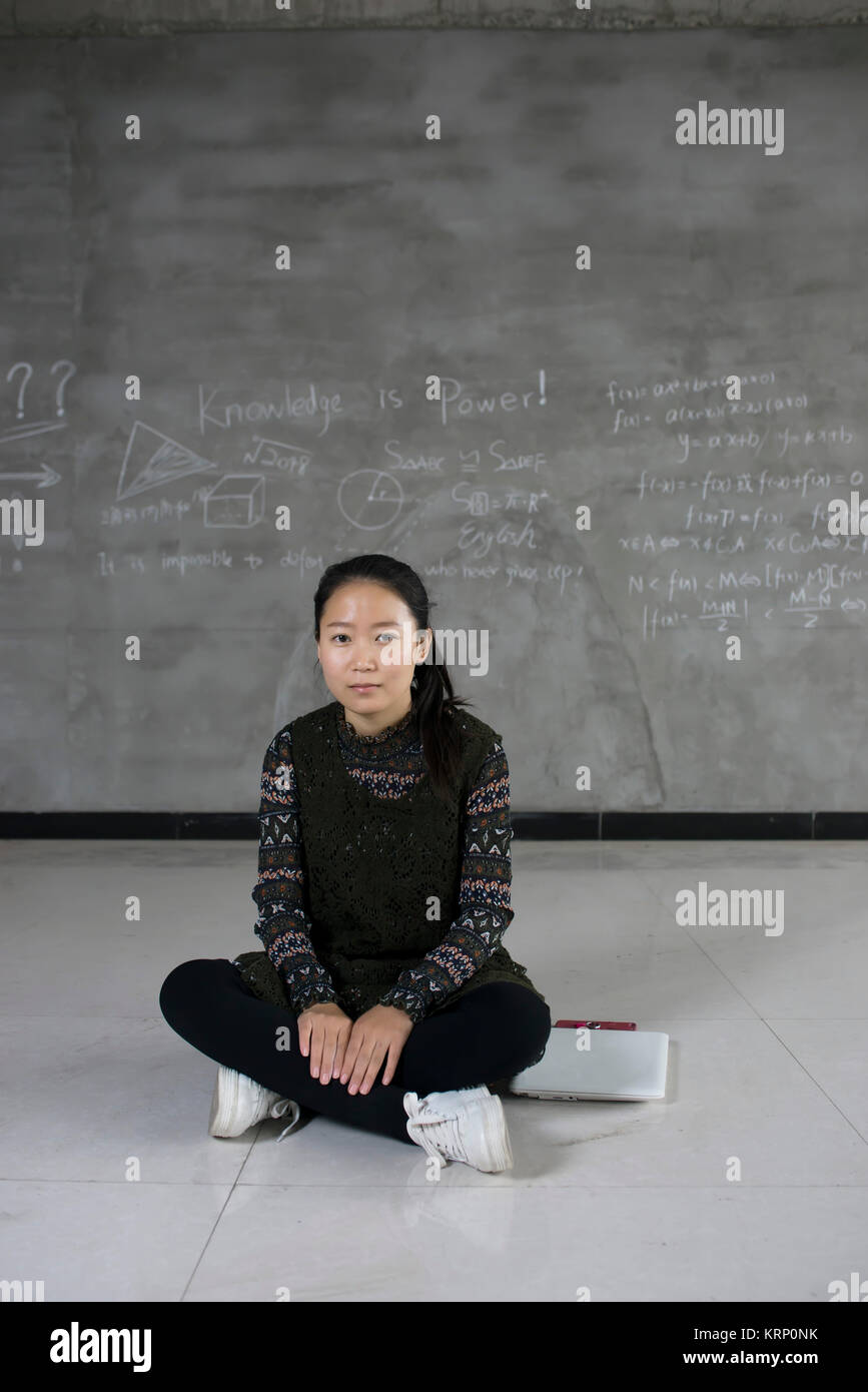 Asian student in a classroomb studying. The background of the ...
