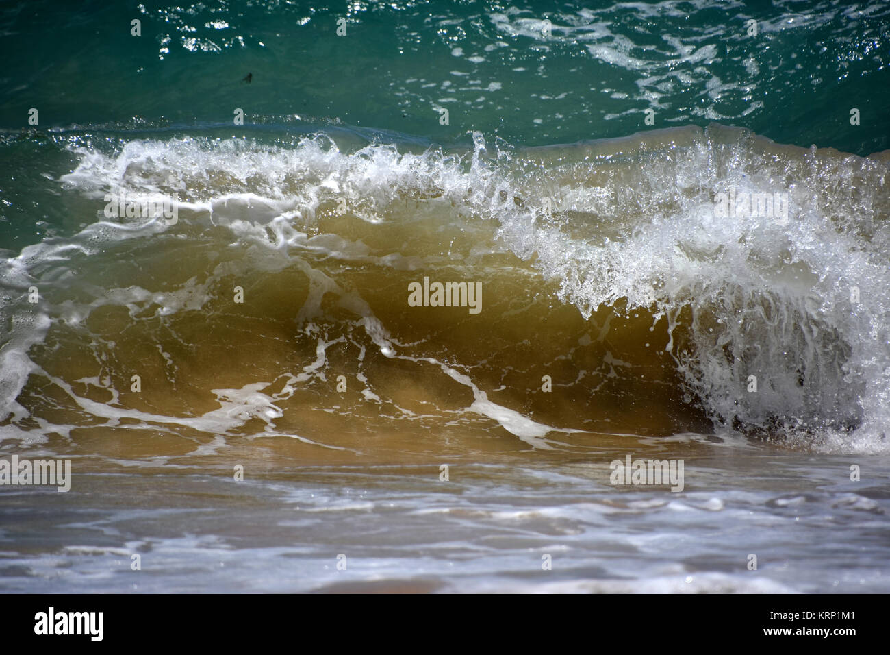 Small Beach waves with foam and sand in the waves Stock Photo - Alamy