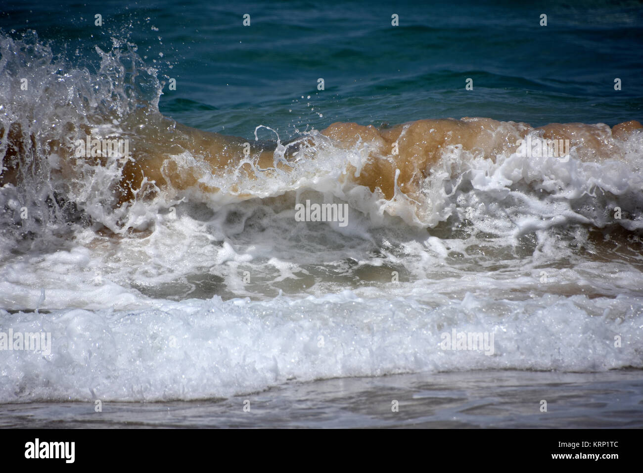 Small Beach waves with foam and sand in the waves Stock Photo - Alamy