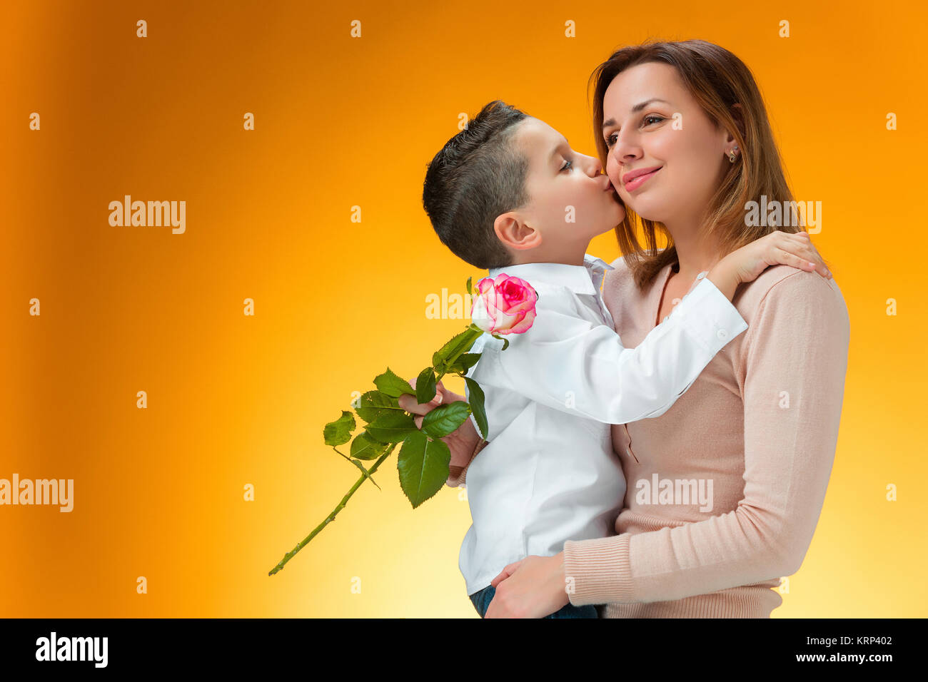 Young kid giving red rose to his mom Stock Photo - Alamy