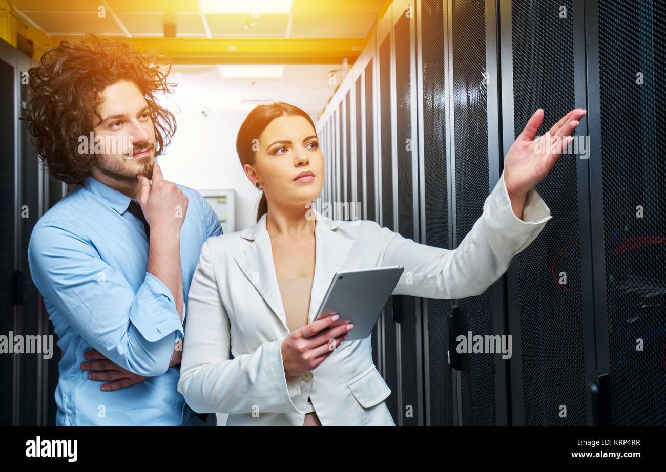 Young couple working at a data center. Black server room Stock Photo ...