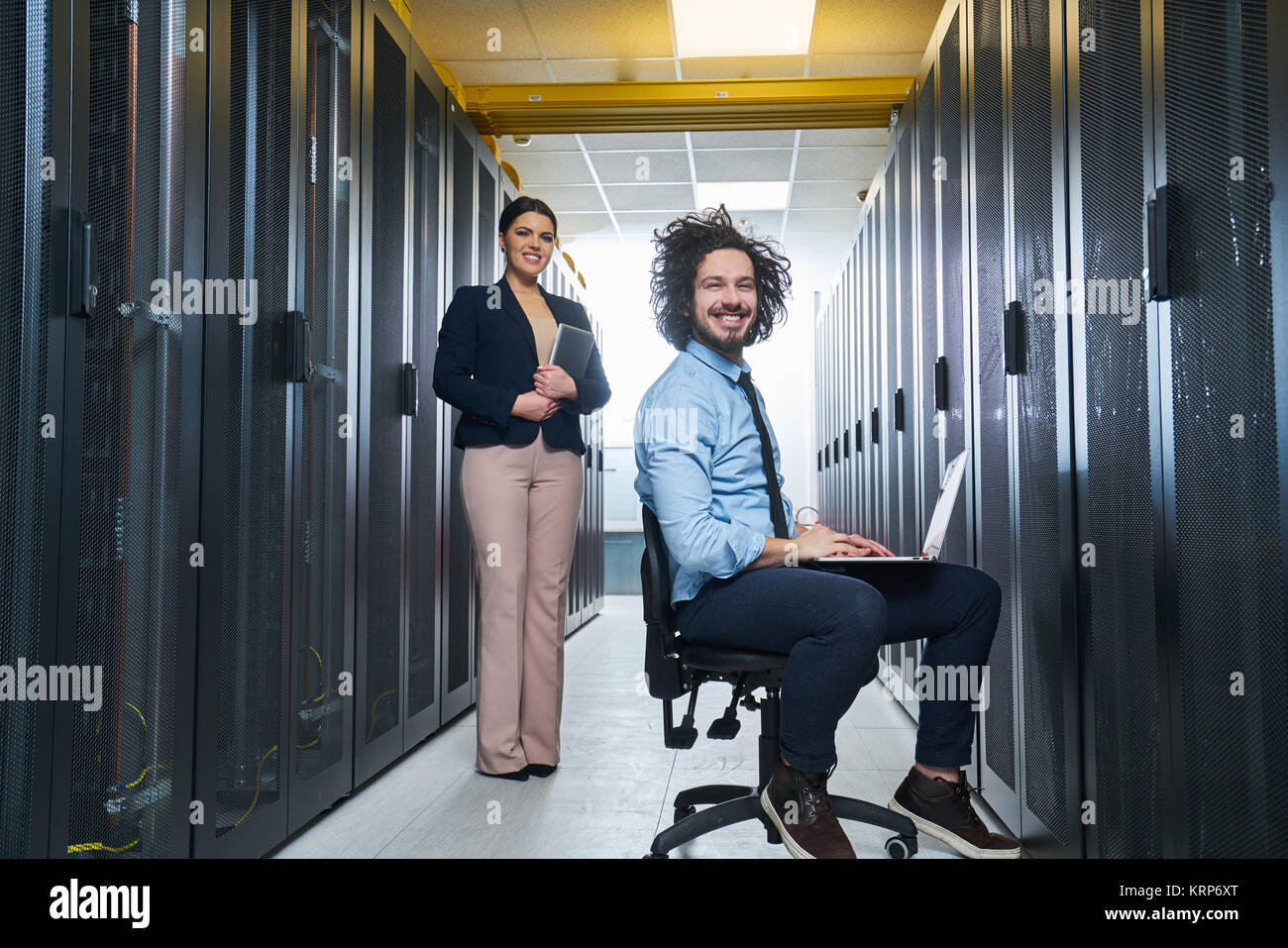 two young technicians working at a data center on server maintenance ...