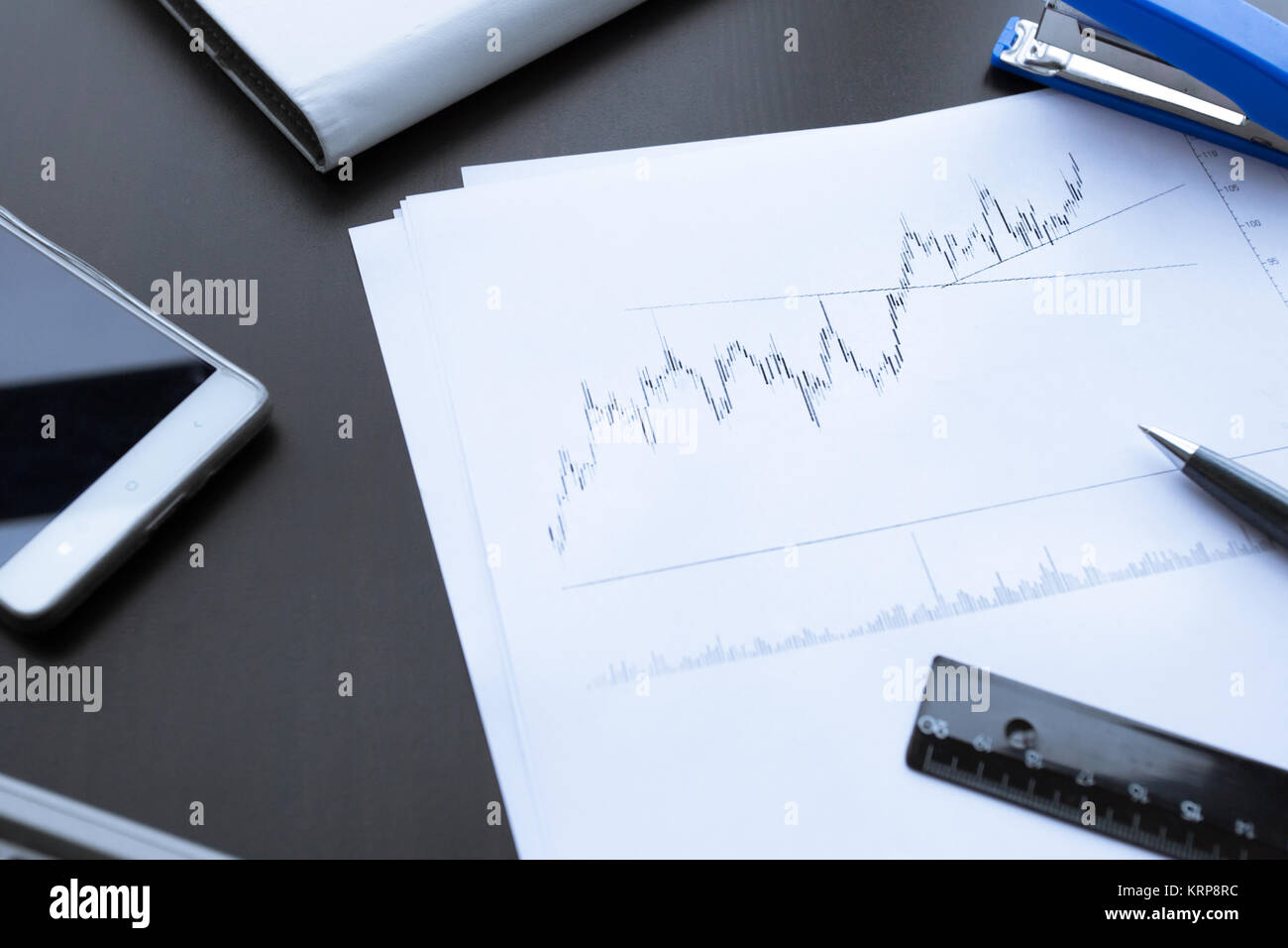 Financial graphs on office table Stock Photo - Alamy