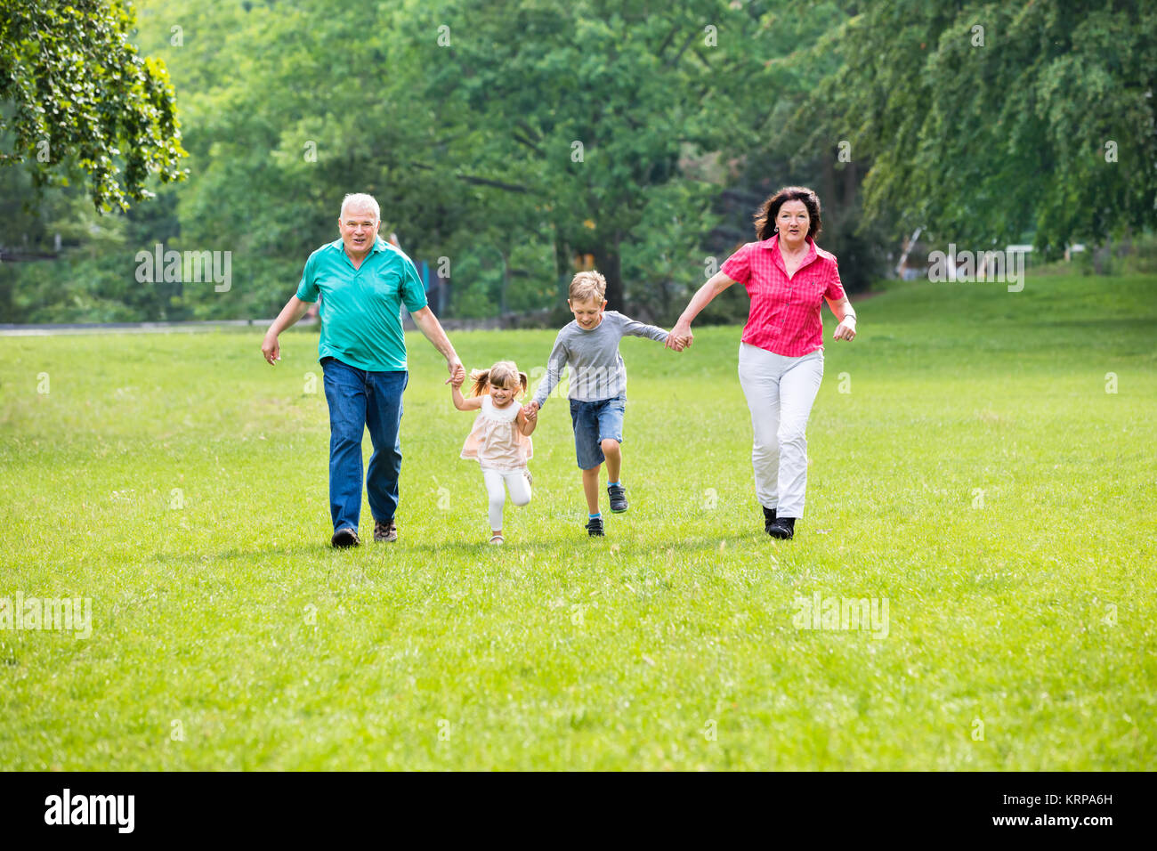 Grandparents And Grandchildren Running In Park Stock Photo - Alamy