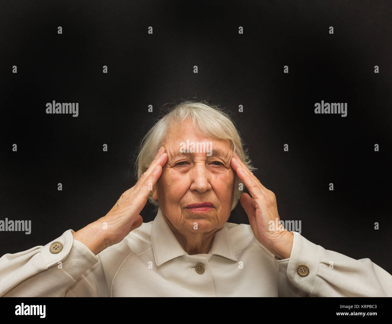 Senior Woman With Head In Hands Looking Weary Stock Photo - Alamy