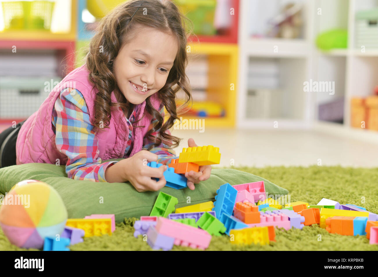 girl playing with colorful plastic blocks Stock Photo - Alamy