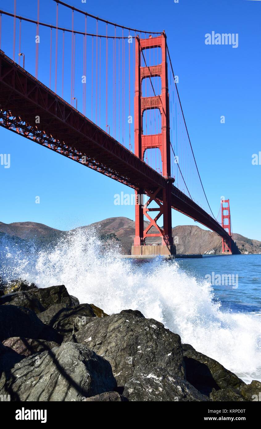 Golden Gate Bridge, from Fort Point with waves crashing on rocks in ...